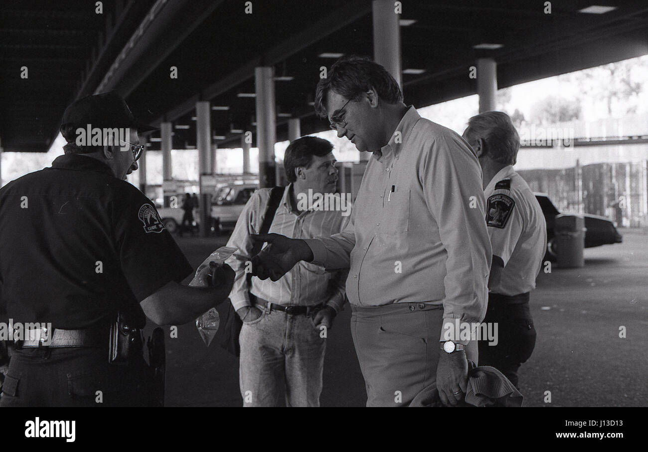 Police officers engage in conversation with individuals to maintain ...