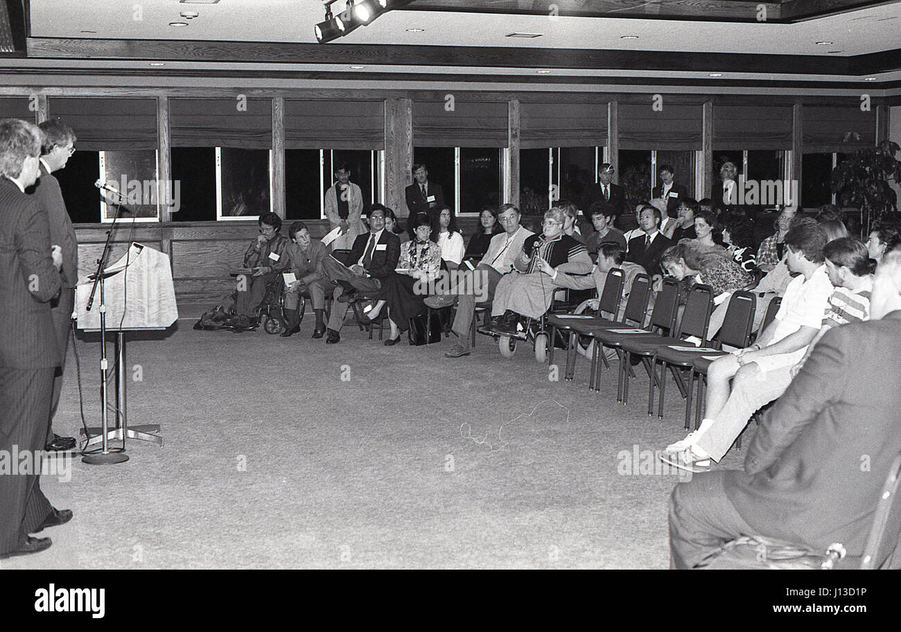 A man speaks at a podium, delivering information or instructions to an ...