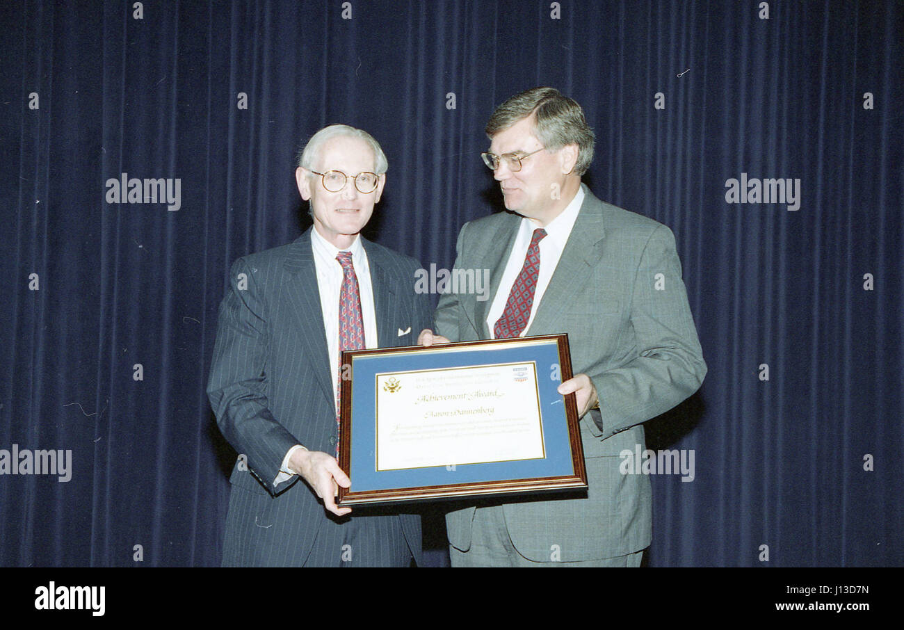 Two men holding an awards certificate Stock Photo - Alamy