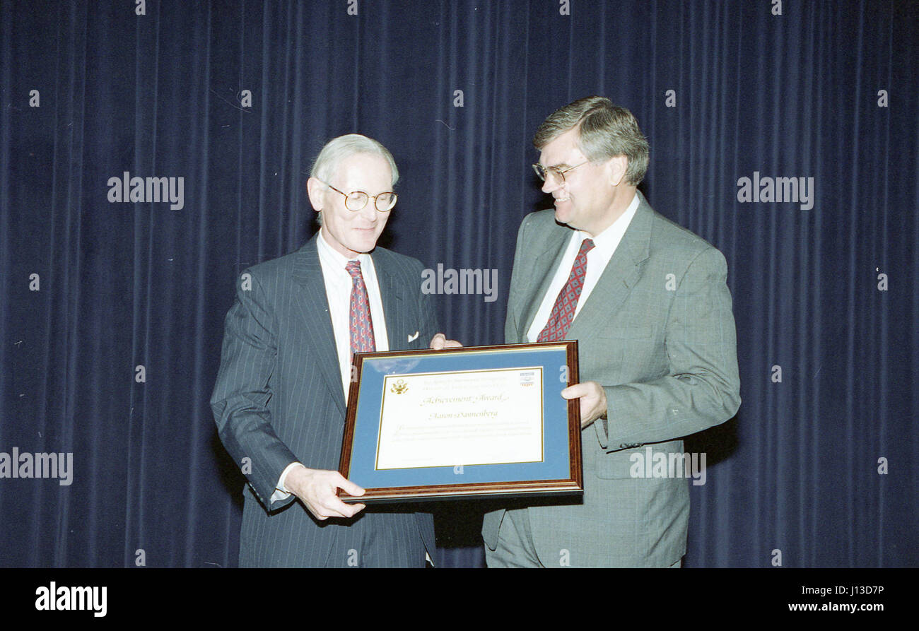 Two men holding an awards certificate Stock Photo - Alamy