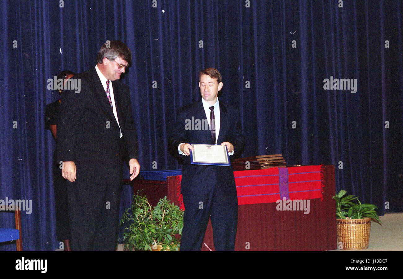 An individual stands on stage to receive an award during a Combined ...