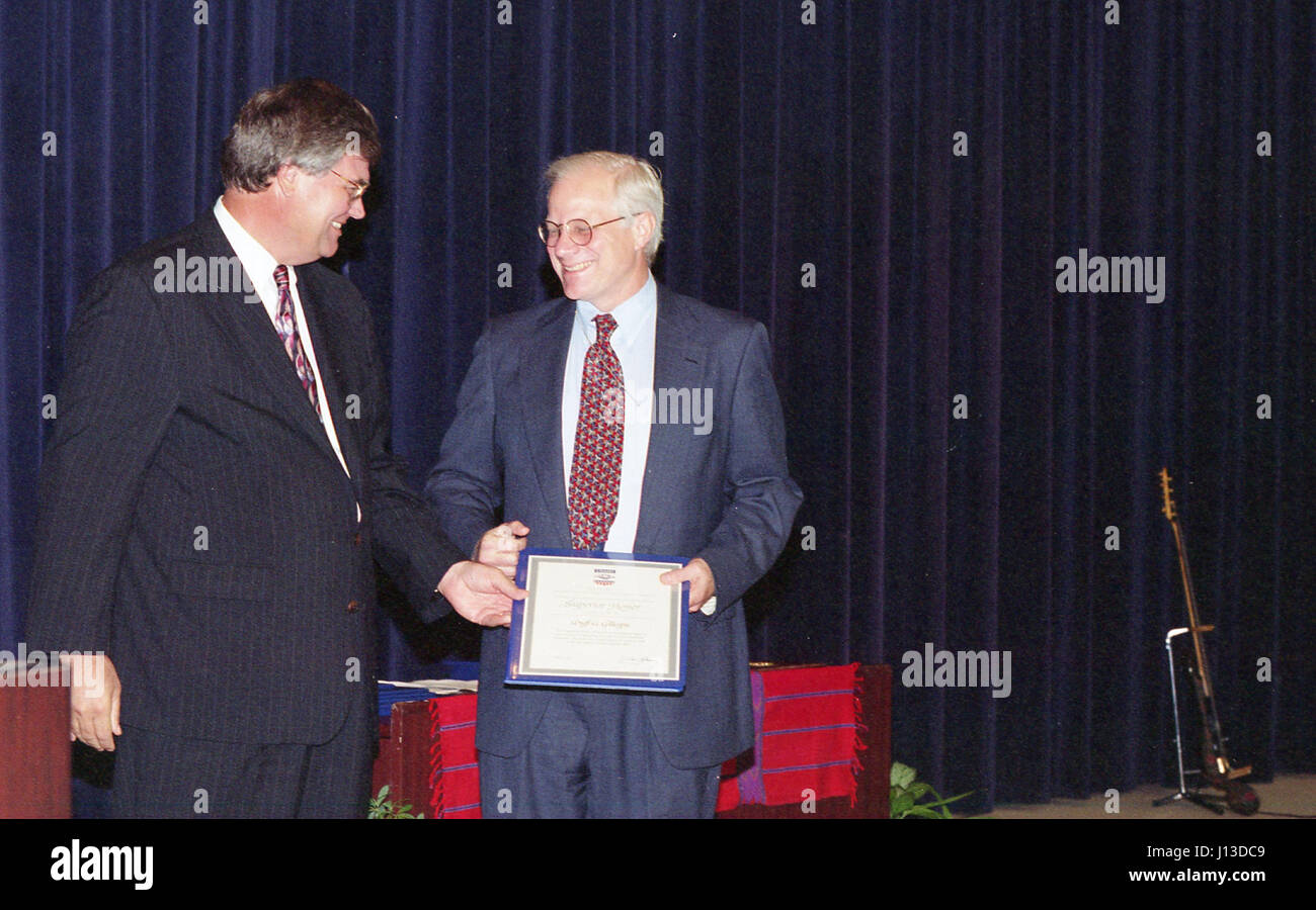 Individual stands on stage to receive an award during a Combined ...