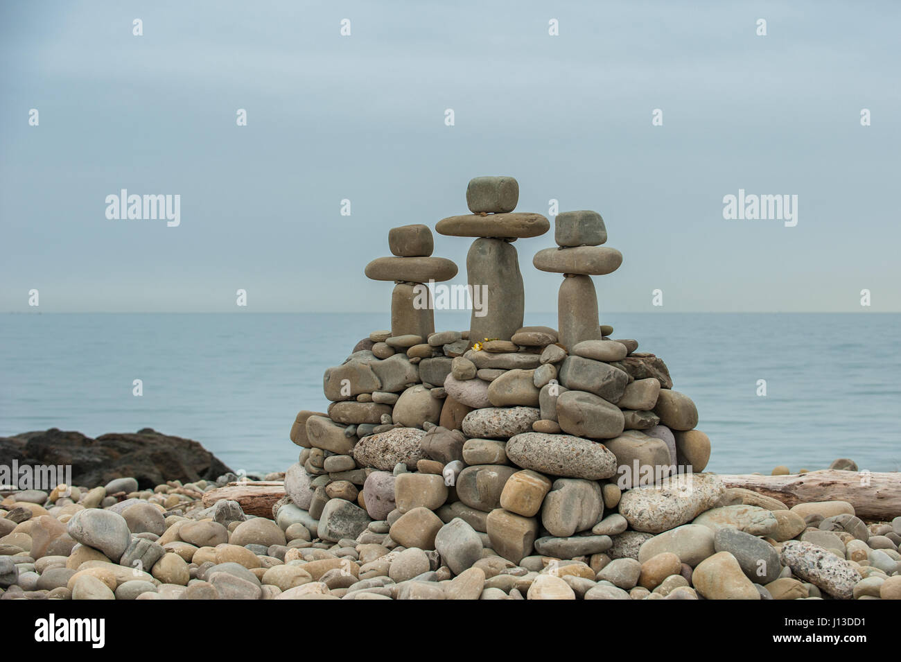 Stone crosses made of balanced rock on Ventura beach with Pacific Ocean ...