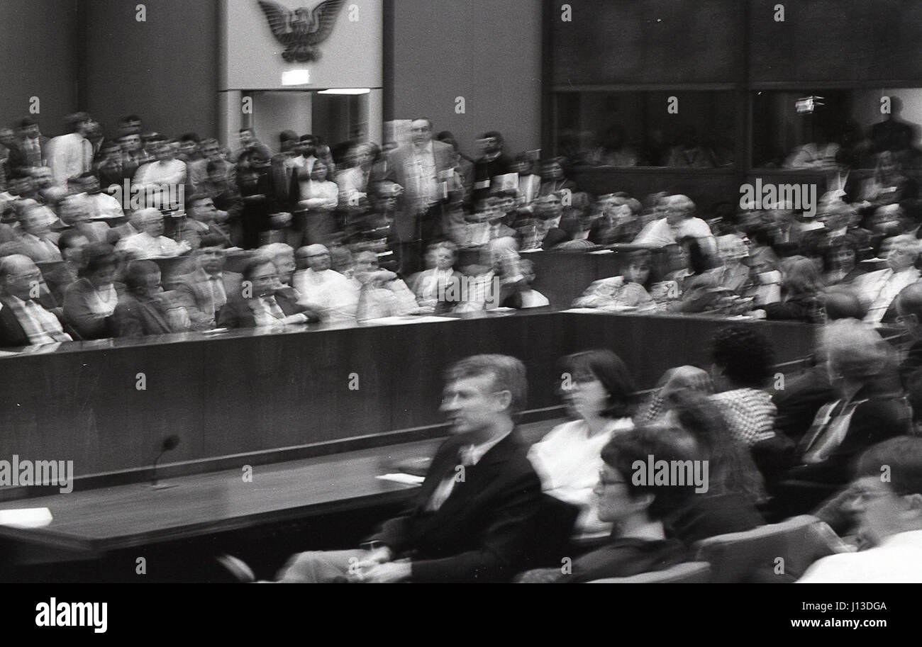 Employees gather in a conference room for a scheduled administrative ...