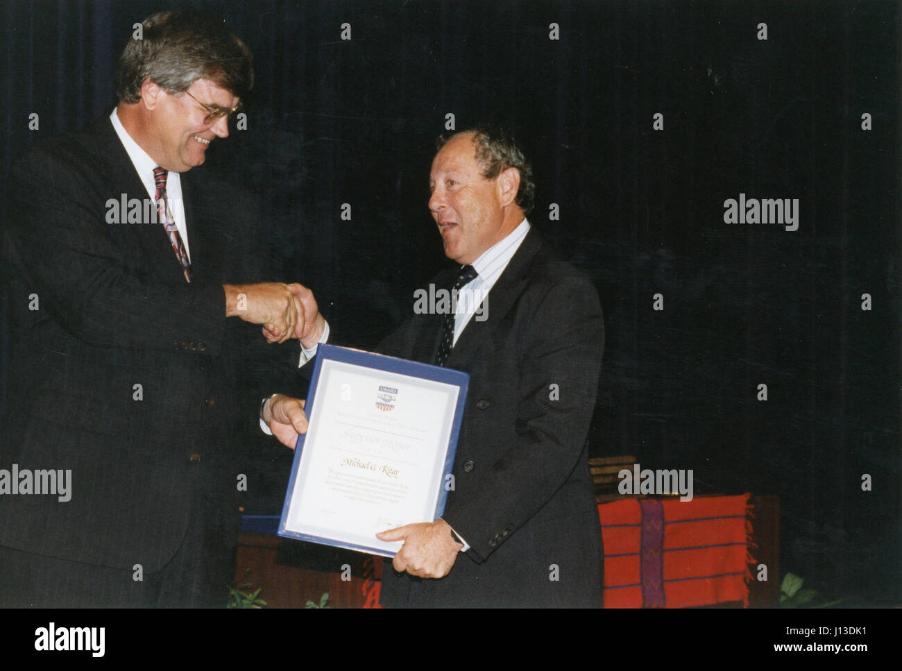An individual receives an award during a formal honors ceremony at ...