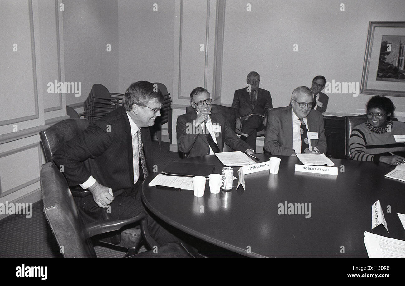 Men and women engage in conversation, sharing information and ...