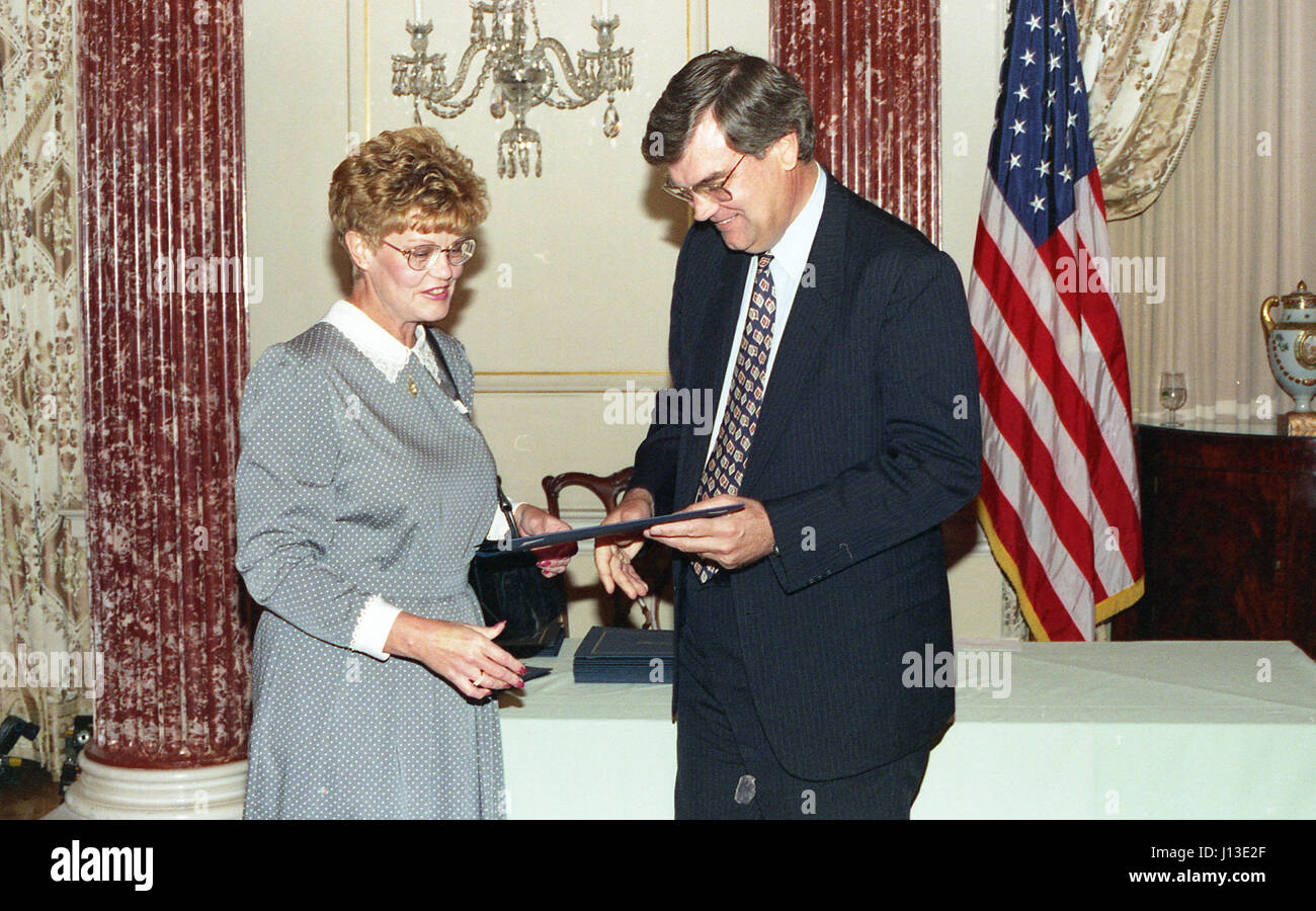 woman accepting award taking a picture Stock Photo - Alamy