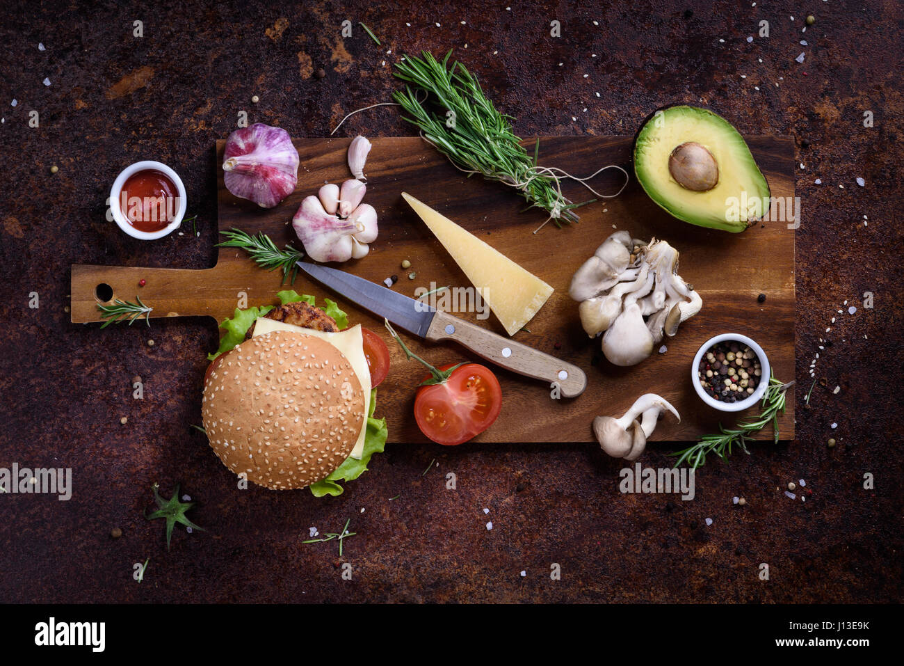 Fresh tasty burger and ingredients on wooden board. Restaurant menu ...