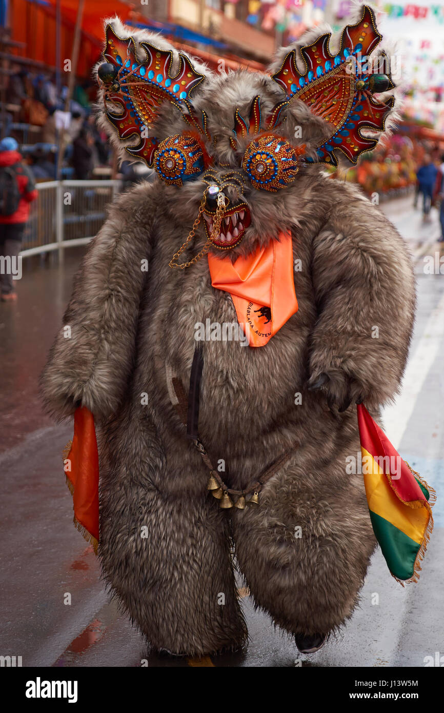 Diablada dancer in ornate bear costume parading through the mining city ...