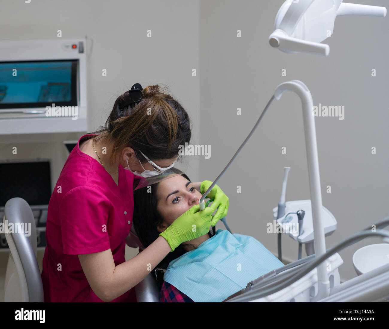 dentist cleaning teeth of woman Stock Photo - Alamy