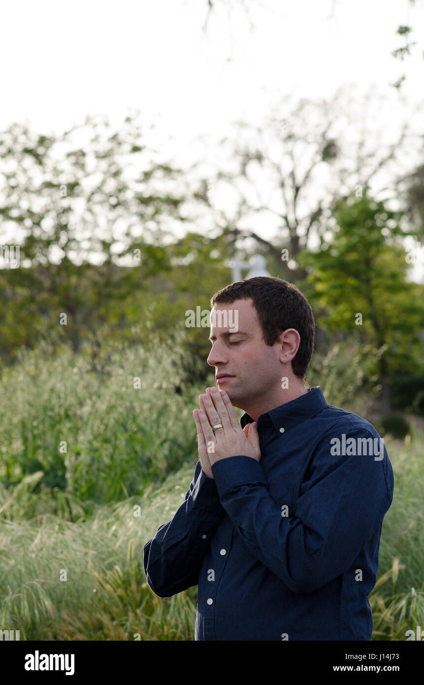 Praying with both hands together hi-res stock photography and images ...