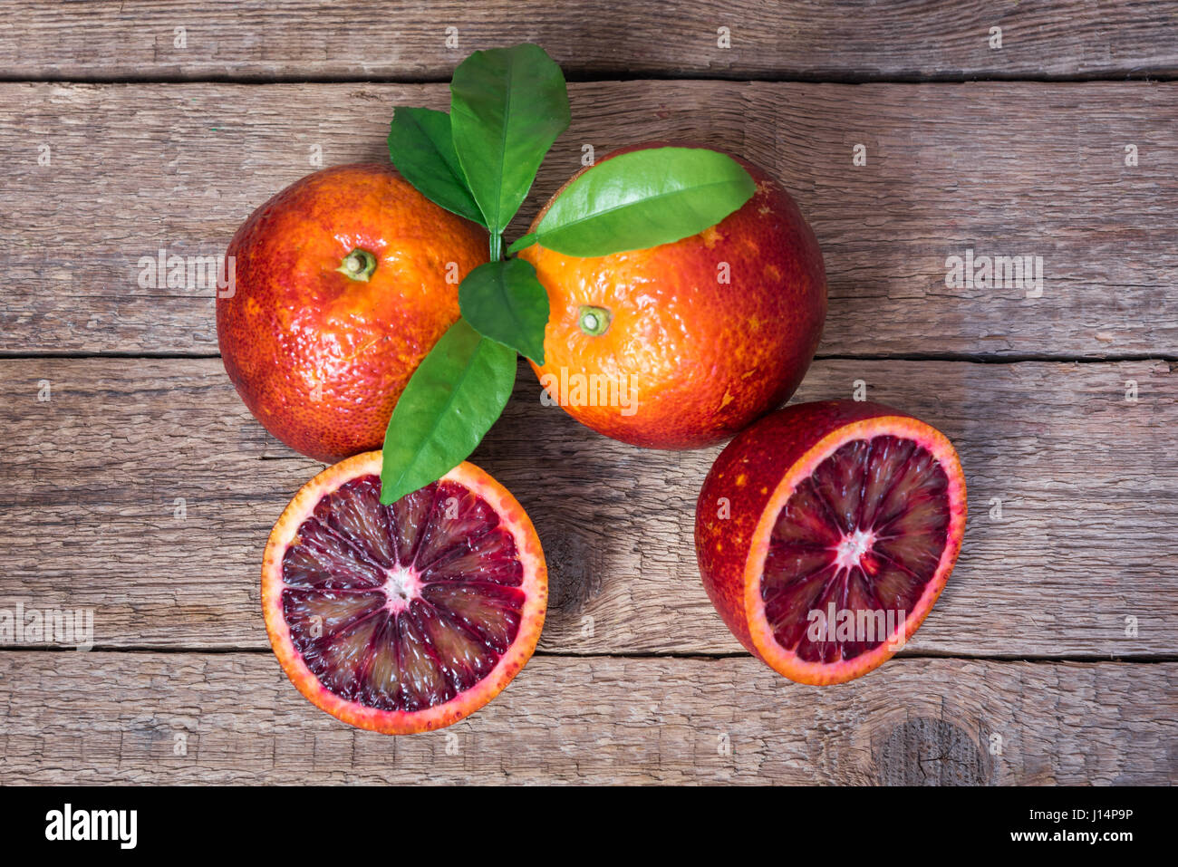 Red sicilian oranges on wood table Stock Photo - Alamy