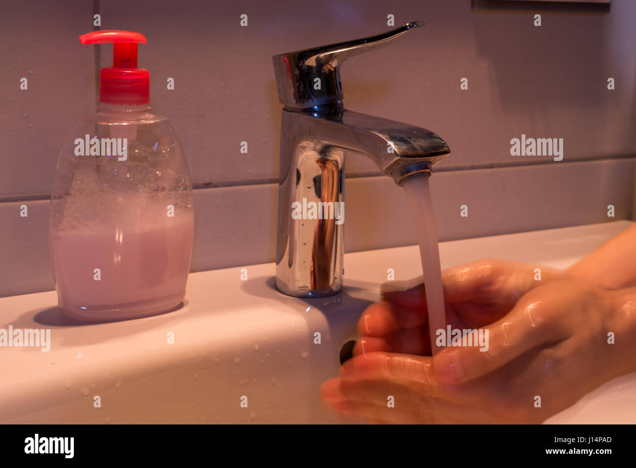 faucet and water stream closeup Stock Photo - Alamy