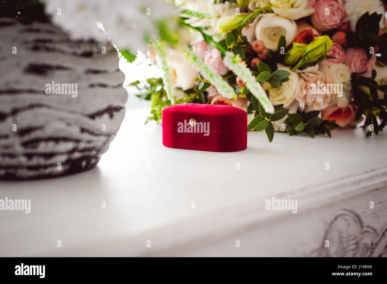 Photo image of a red velvet box with wedding rings of the bride and ...