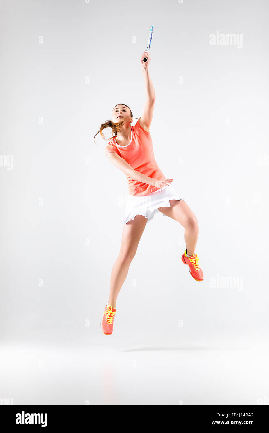 Young woman playing badminton over white background Stock Photo - Alamy