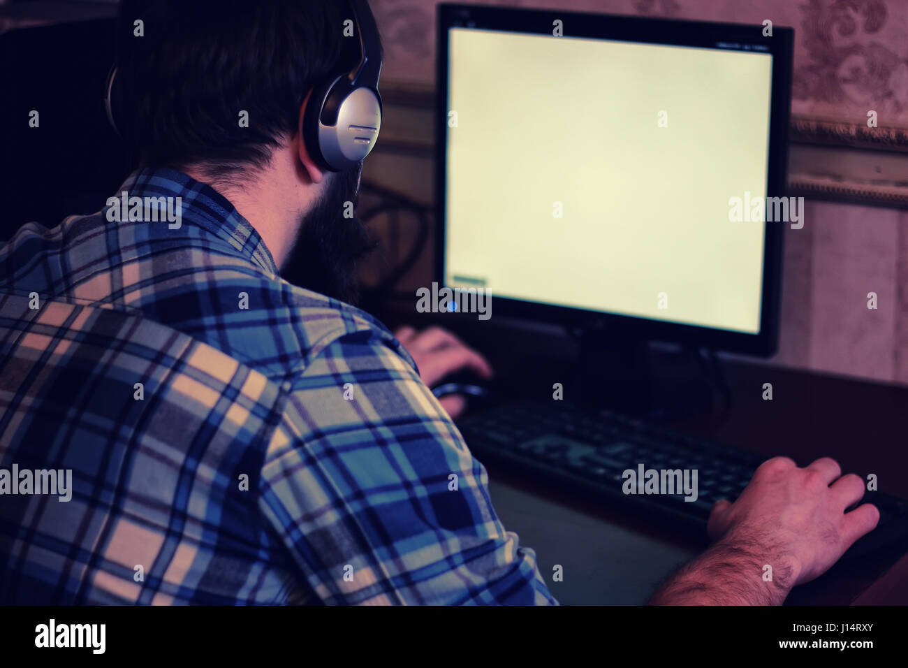 male behind computer with headphones Stock Photo - Alamy
