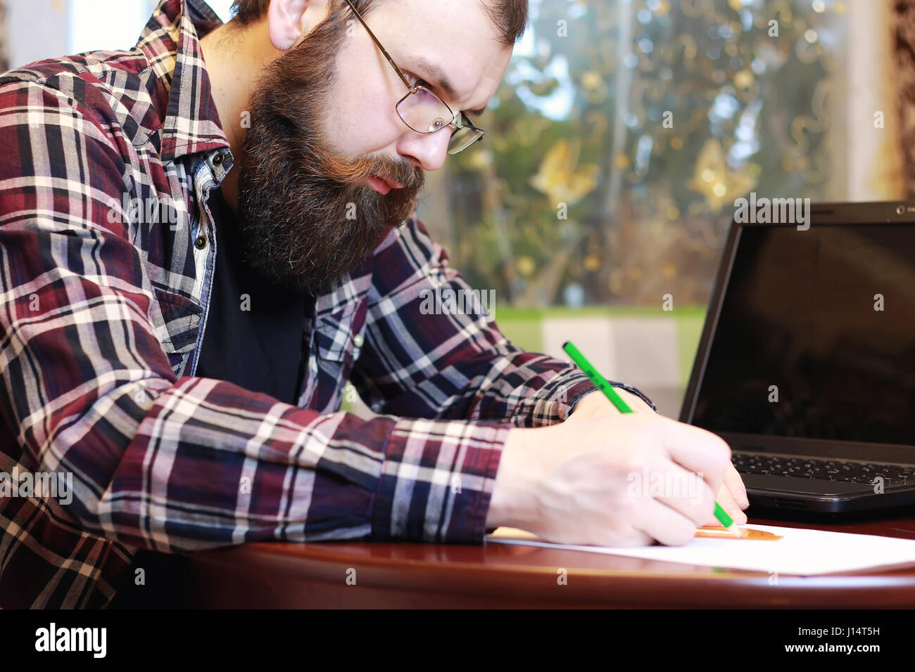 male notebook work bearded Stock Photo - Alamy