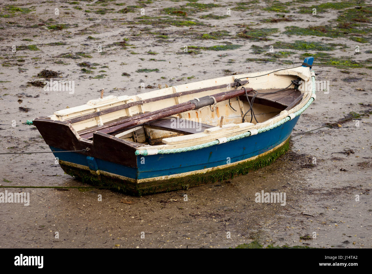 Little fishing boat stranded on the wet sand by low tide Stock Photo ...