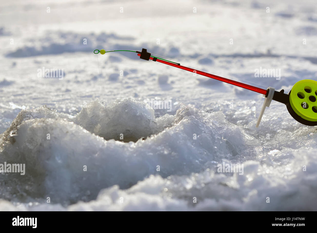 Little winter fishing rod ice Stock Photo - Alamy