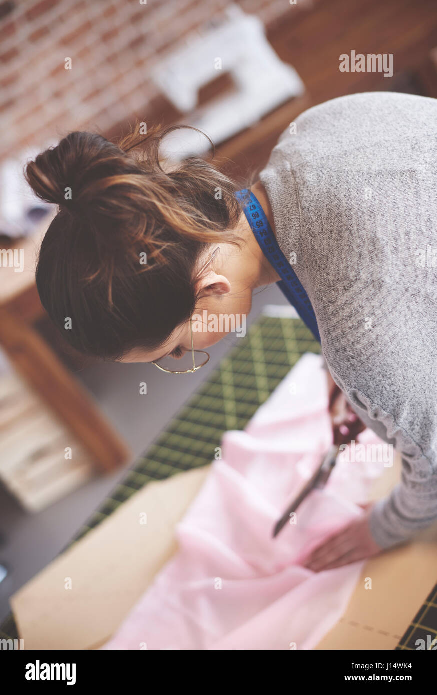 Woman cutting fabric with scissors Stock Photo - Alamy