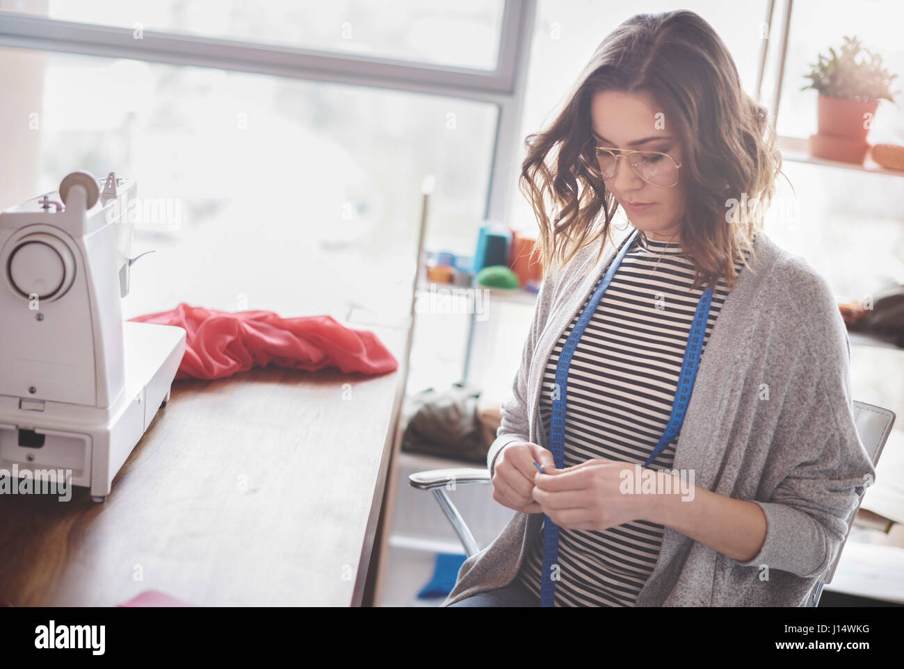 Close up of female fashion designer during work Stock Photo - Alamy