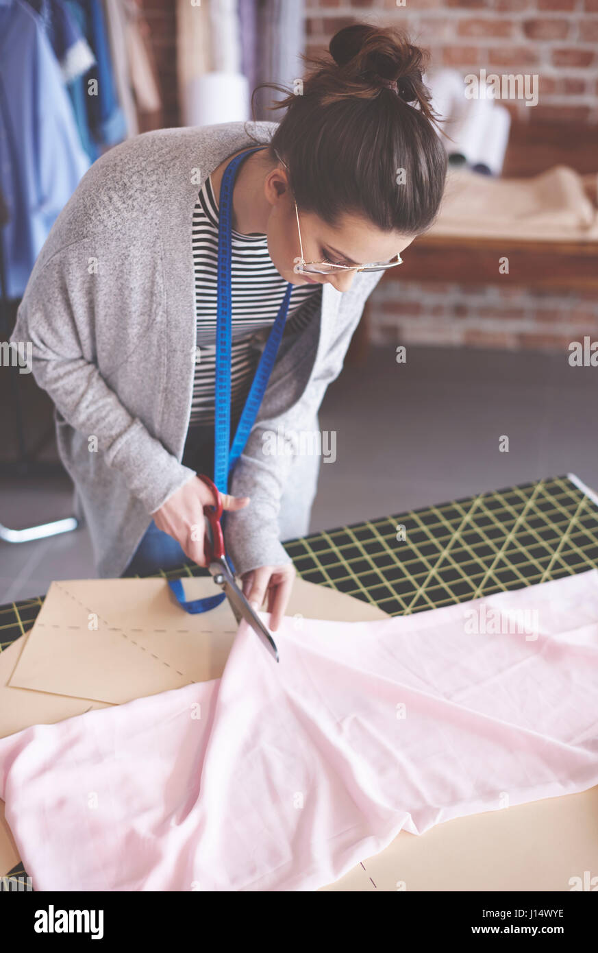 Female design professional cutting fabric Stock Photo - Alamy