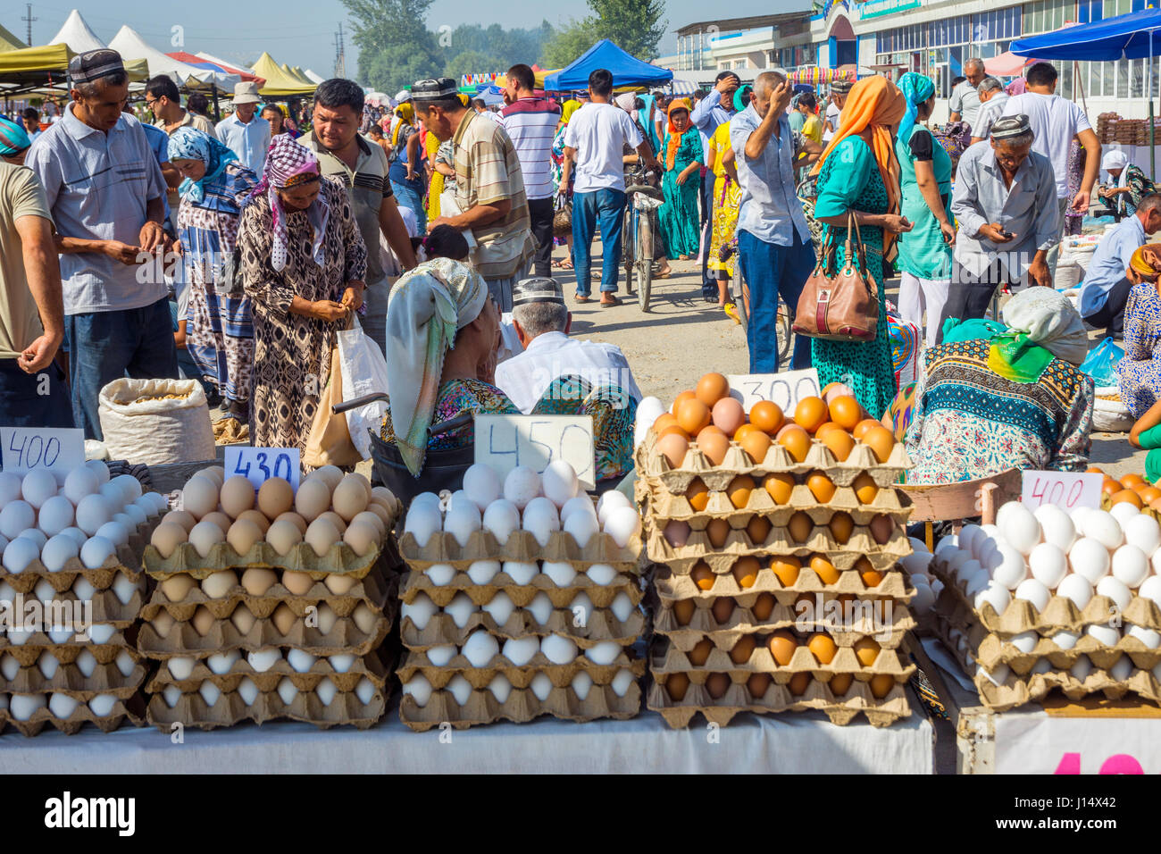 MARGILAN, UZBEKISTAN - AUGUST 21: Eggs for sale and a crowd of people ...