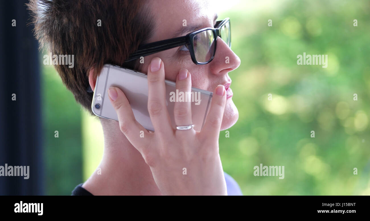 female manager using cell telephone in office interior Stock Photo - Alamy