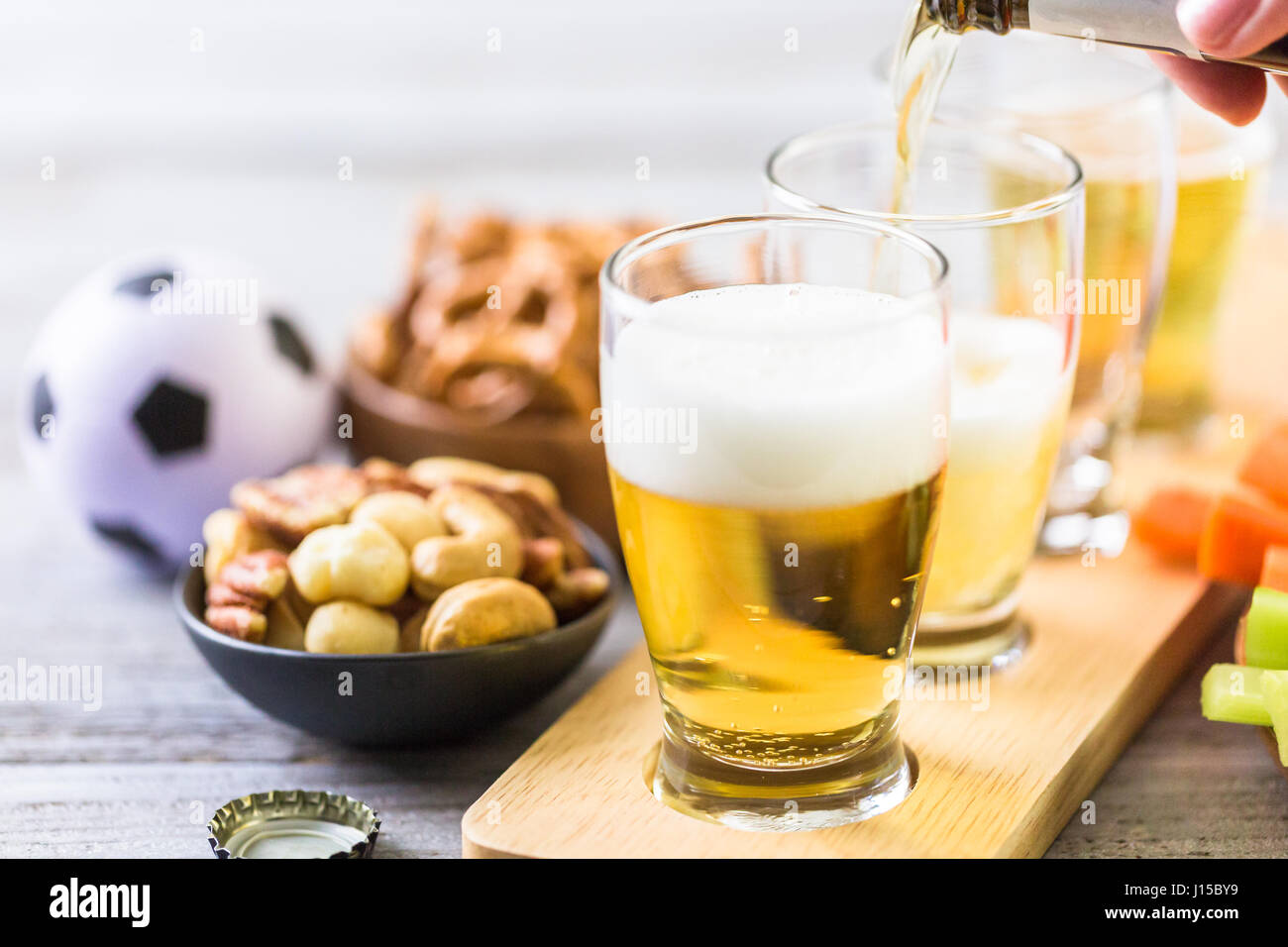 Step by step. Pouring draft beer into beer glass Stock Photo - Alamy