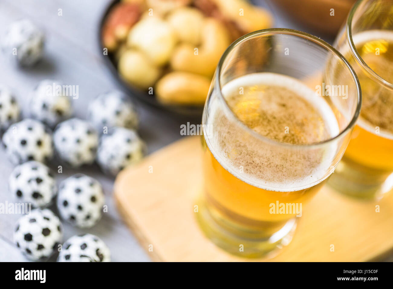 Draft beer and salty snacks on the table for soccer party Stock Photo ...