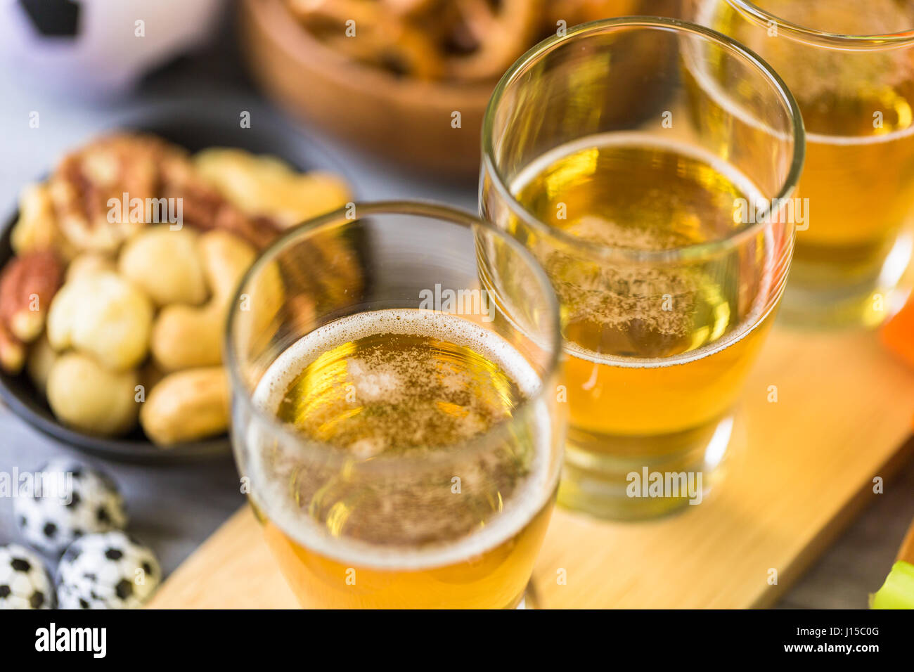 Draft beer and salty snacks on the table for soccer party Stock Photo ...