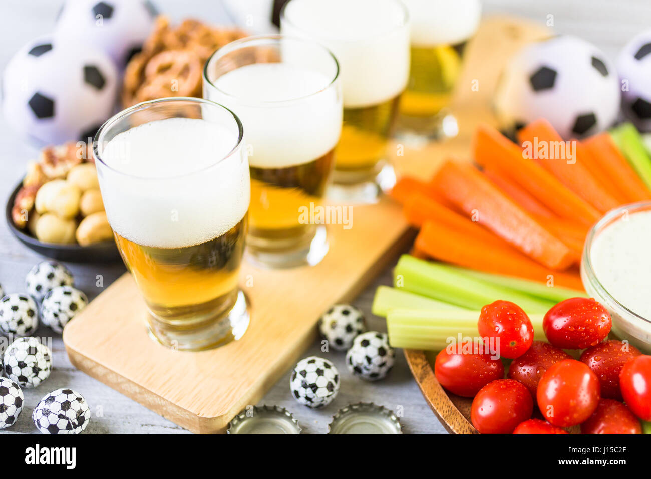 Draft beer and salty snacks on the table for soccer party Stock Photo ...