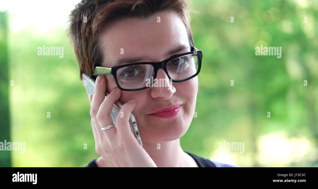 female manager using cell telephone in office interior Stock Photo - Alamy