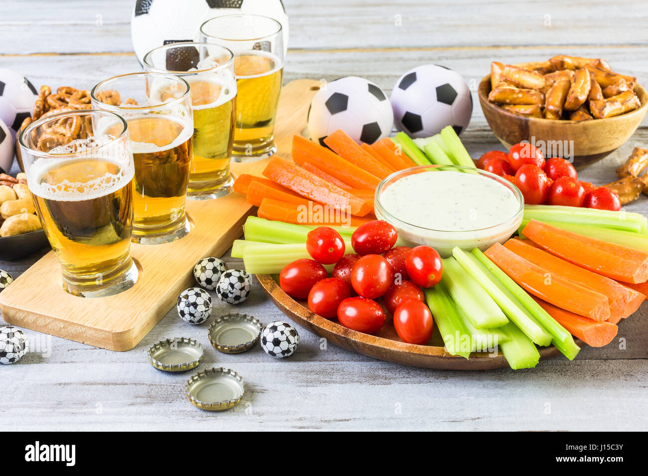 Draft beer and salty snacks on the table for soccer party Stock Photo ...