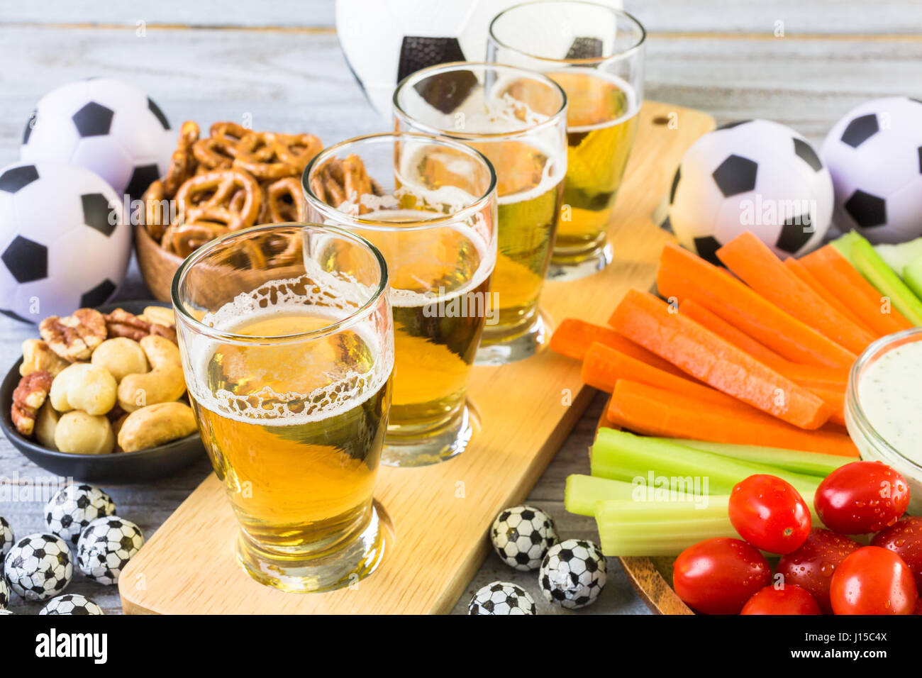Draft beer and salty snacks on the table for soccer party Stock Photo ...