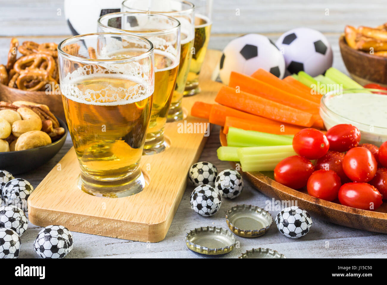 Draft beer and salty snacks on the table for soccer party Stock Photo ...