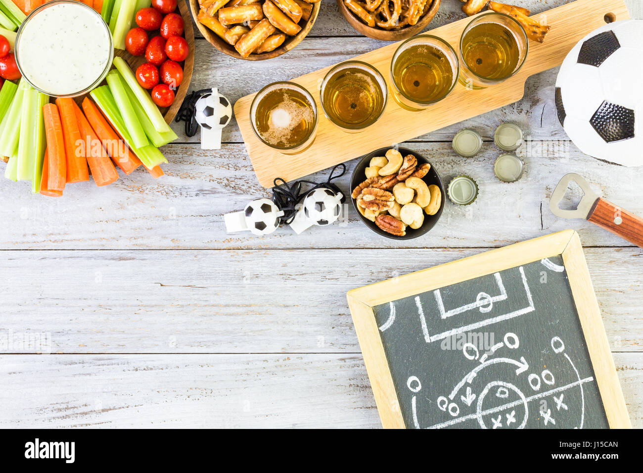 Draft beer and salty snacks on the table for soccer party Stock Photo ...