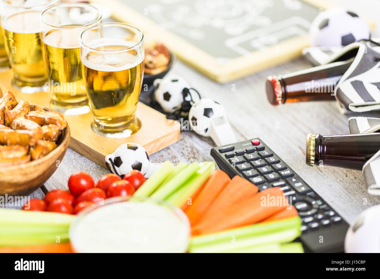 Draft beer and salty snacks on the table for soccer party Stock Photo ...