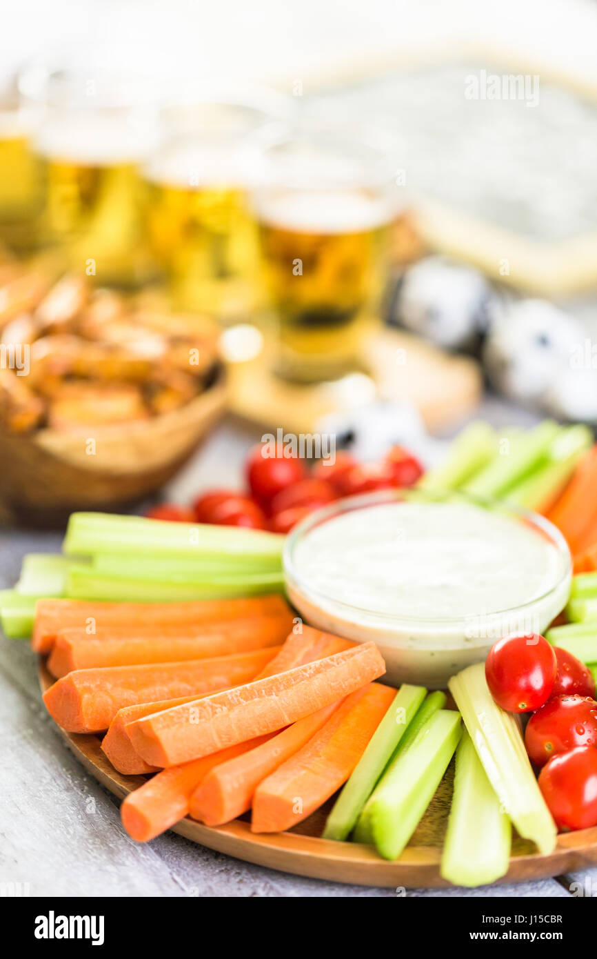 Draft beer and salty snacks on the table for soccer party Stock Photo ...