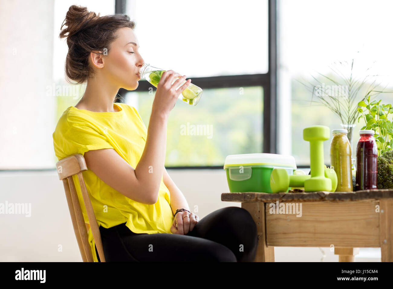Woman drinking water indoors Stock Photo - Alamy