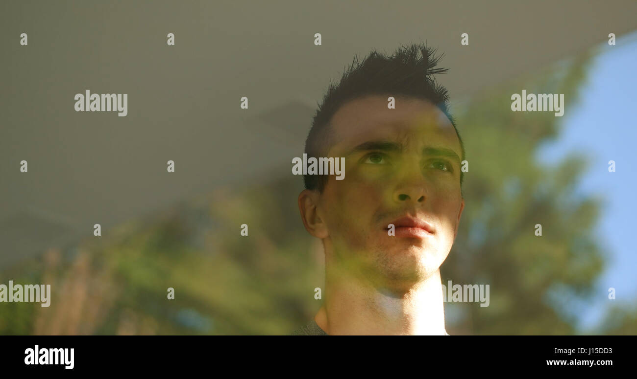 Sad, Depressed Man looking through The Window At Home Stock Photo - Alamy