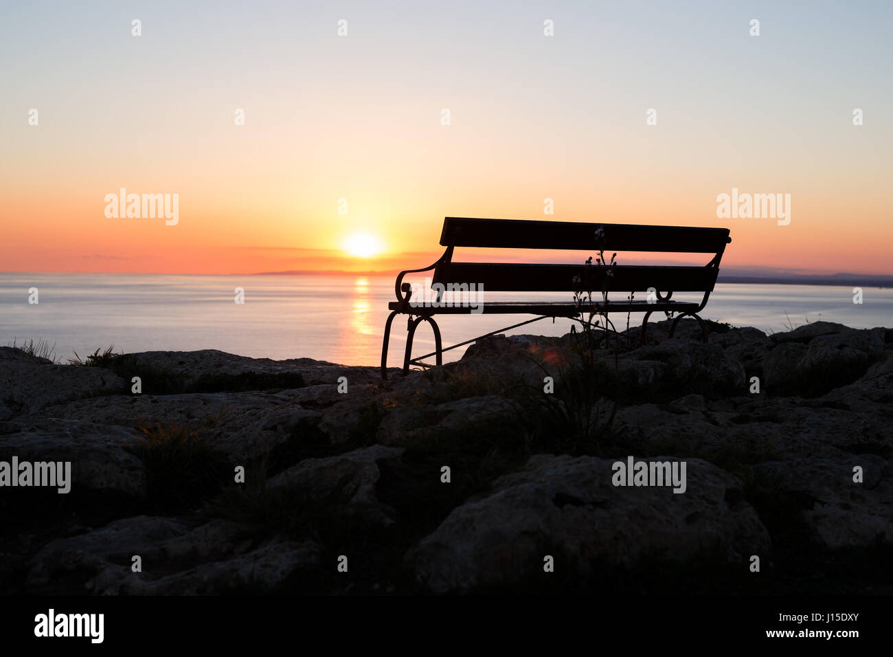Sunset beach and bench Stock Photo - Alamy
