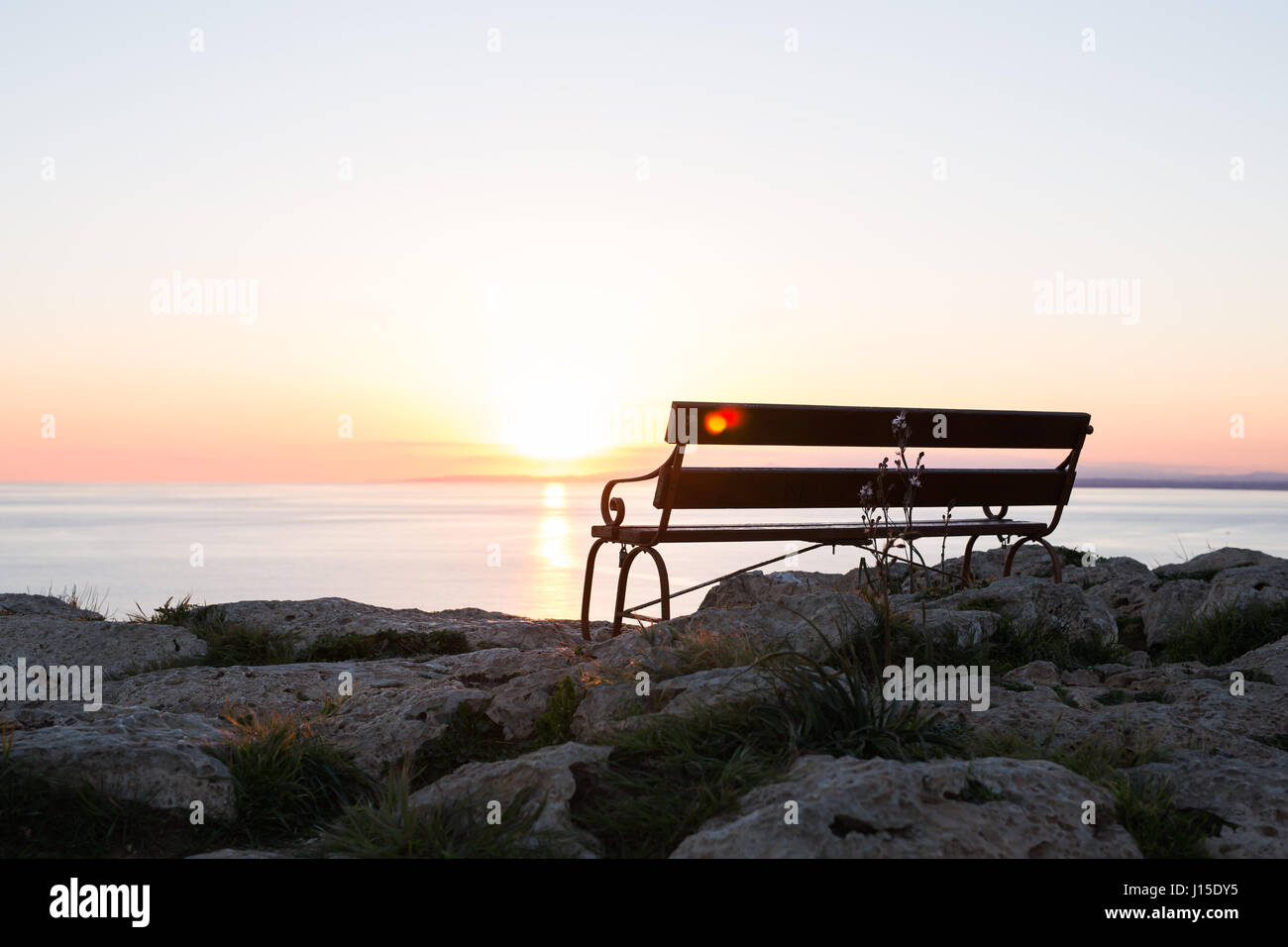 Sunset beach and bench Stock Photo - Alamy