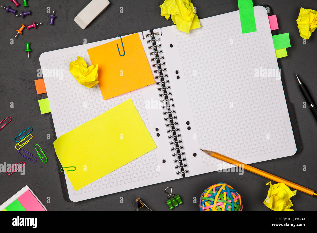 Open notepad with office supplies Stock Photo - Alamy