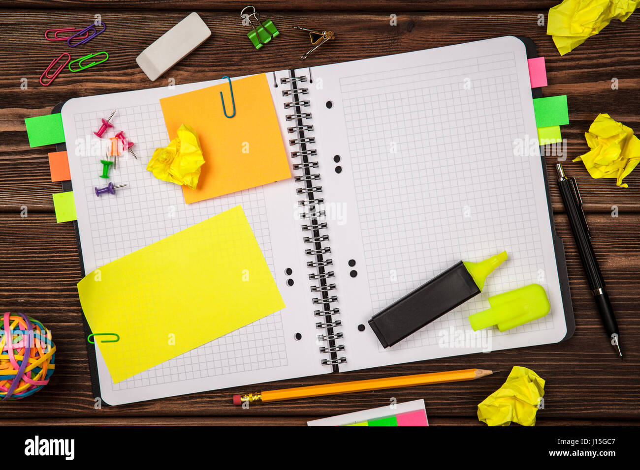 Open notepad with office supplies Stock Photo - Alamy