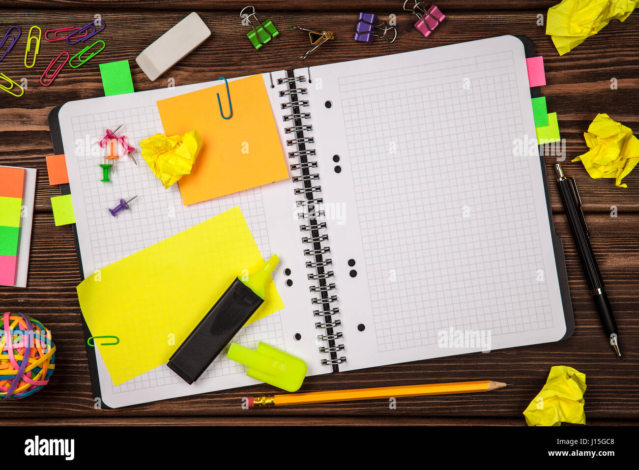 Open notepad with office supplies Stock Photo - Alamy