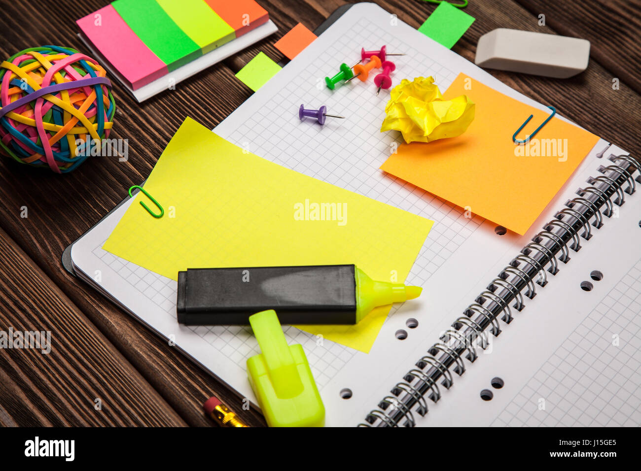 Open notepad with office supplies Stock Photo - Alamy