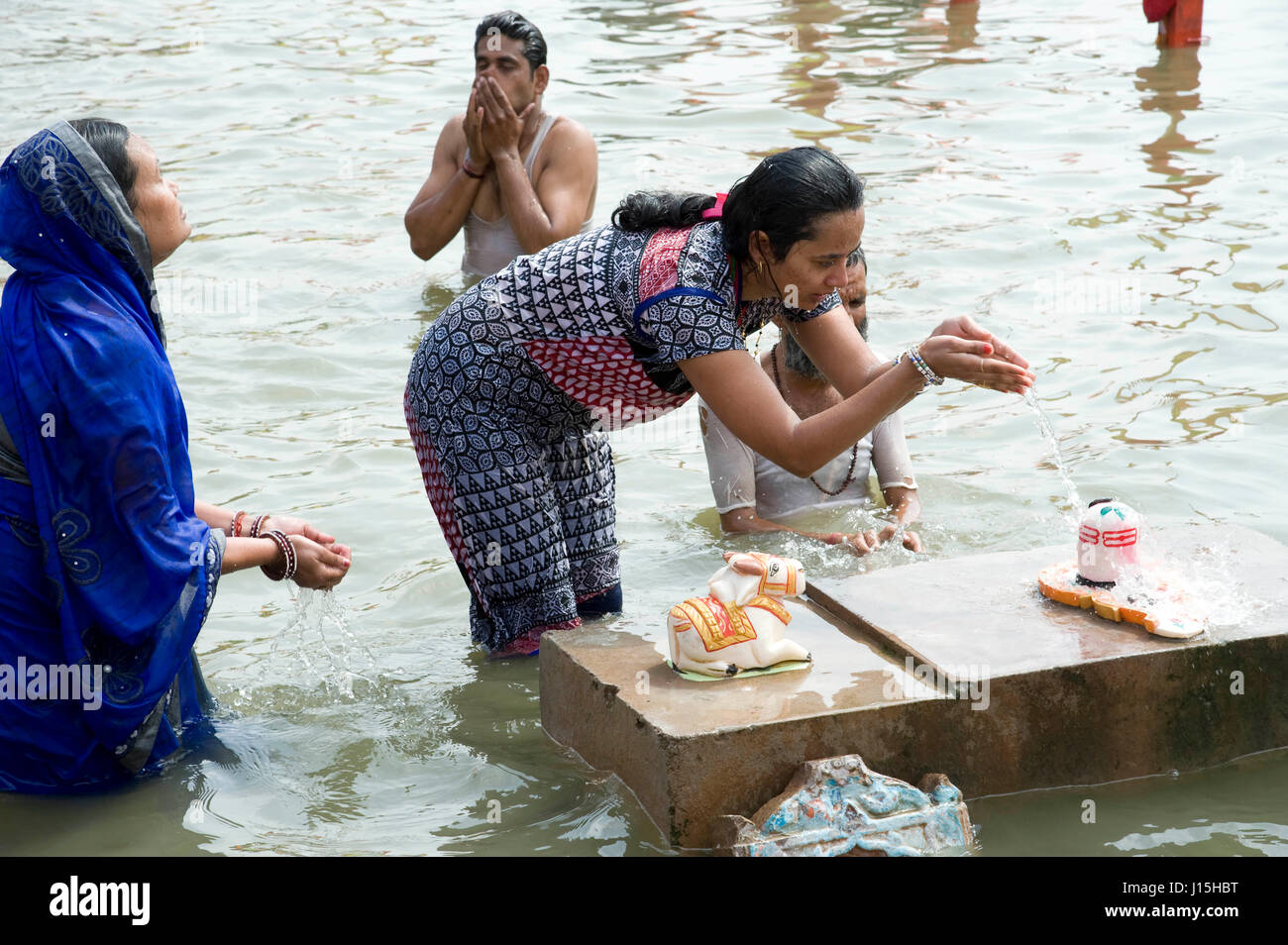 Woman offering water on shivling hi-res stock photography and images ...