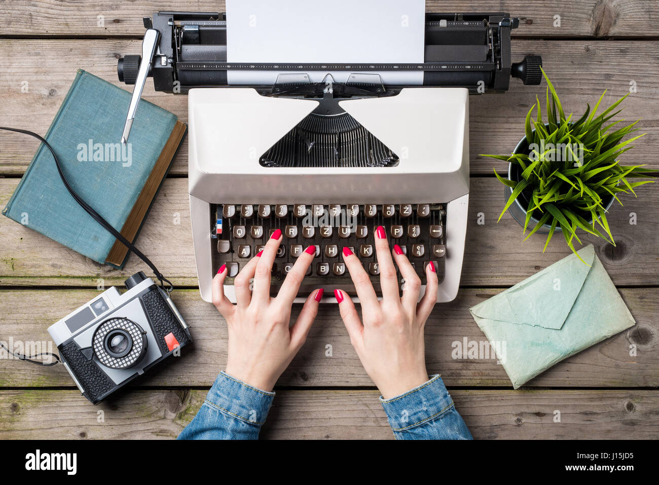 Woman writing on an old typewriter Stock Photo - Alamy
