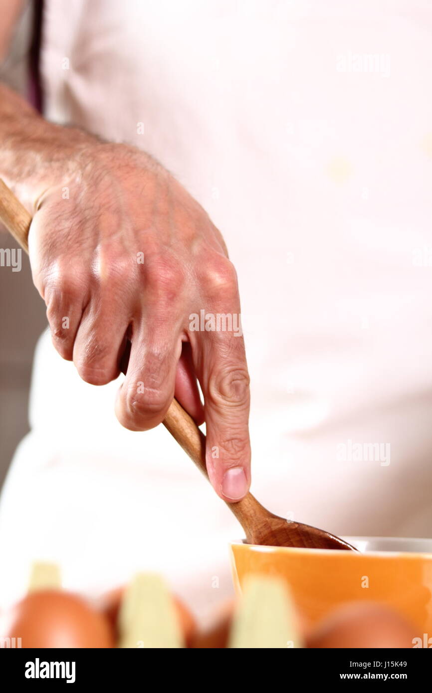 Whisking emulsion. Making mayonnaise with a wooden spoon Stock Photo ...
